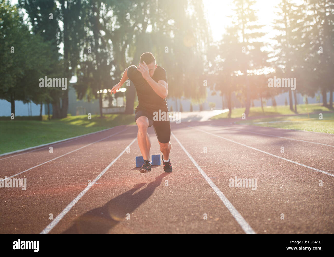 Sprinter leaving starting blocks on the running track. Explosive start ...