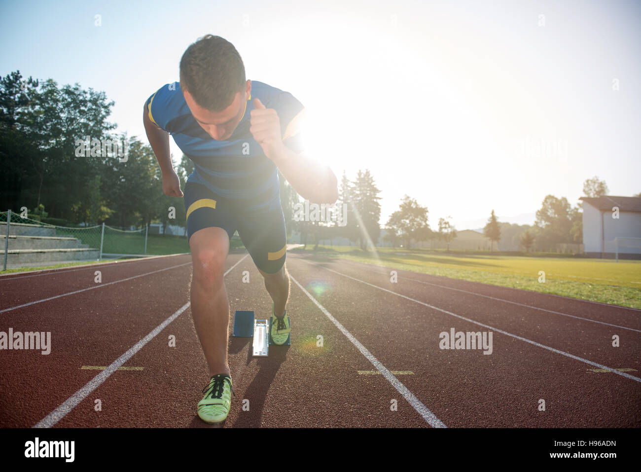 Sprinter leaving starting blocks on the running track. Explosive start ...
