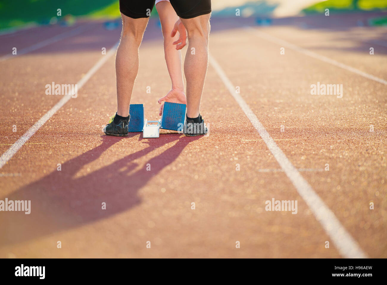 Close-up of feet of an athlete on a starting block about to run Stock ...
