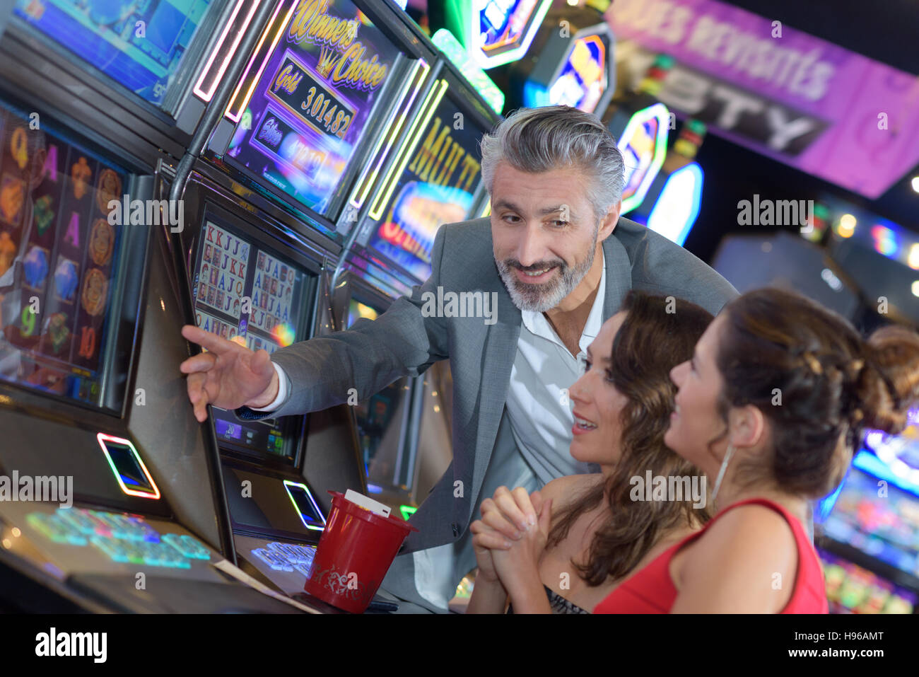 Young man playing slot machines hi-res stock photography and images - Alamy