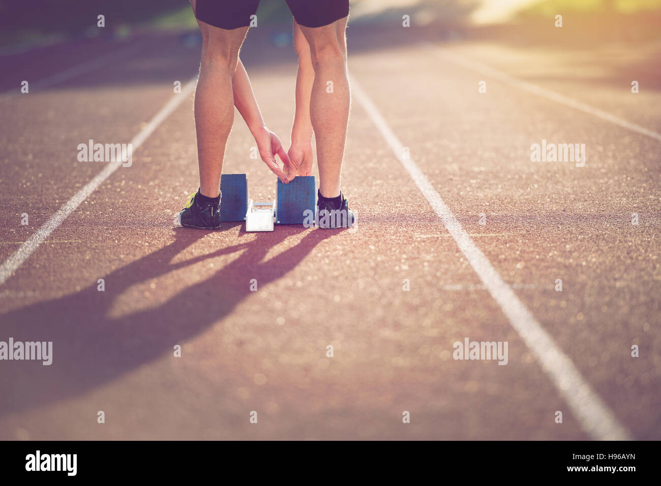Close-up of feet of an athlete on a starting block about to run Stock ...