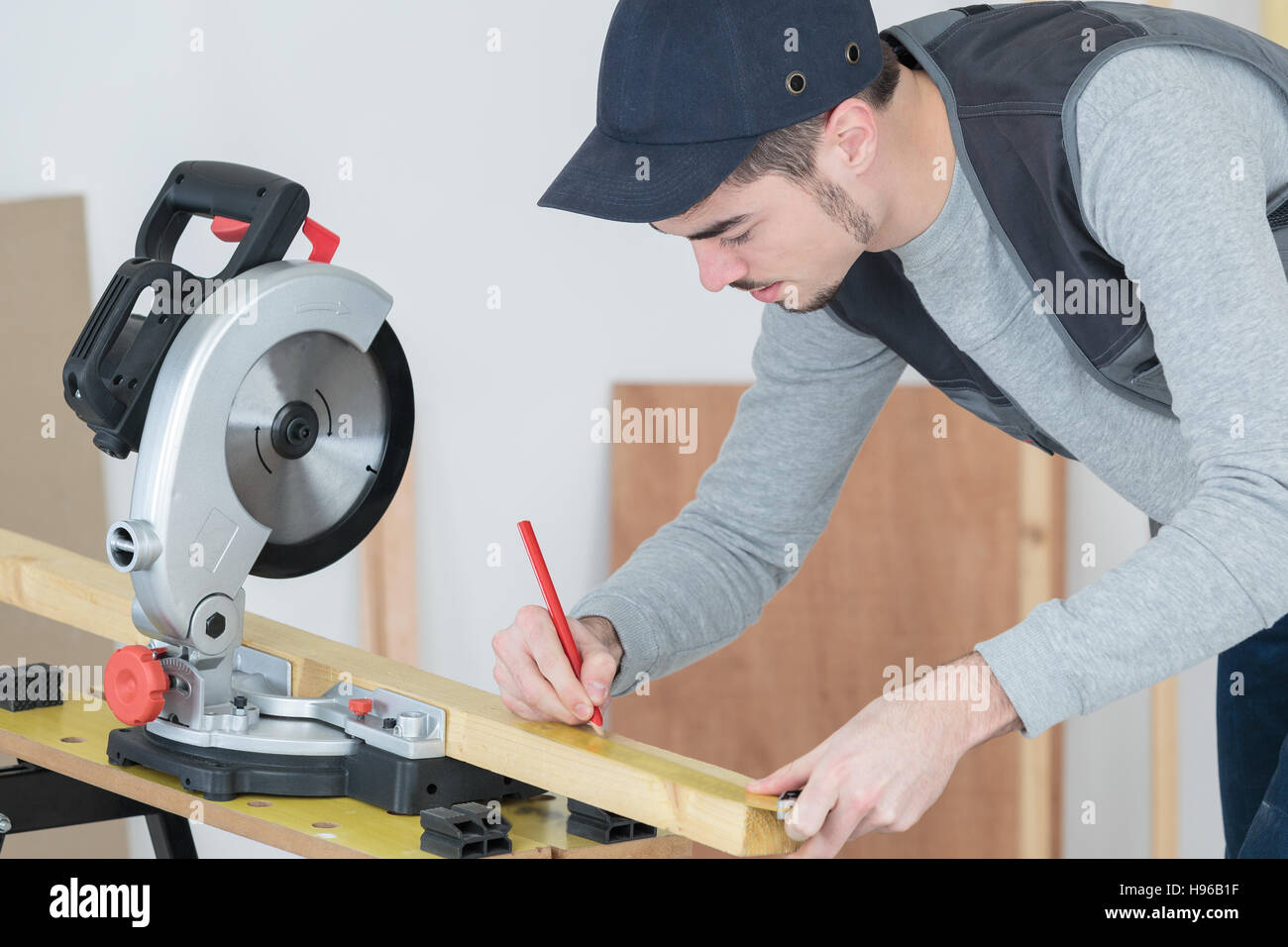 carpenter at work carefully looking at the plans Stock Photo - Alamy