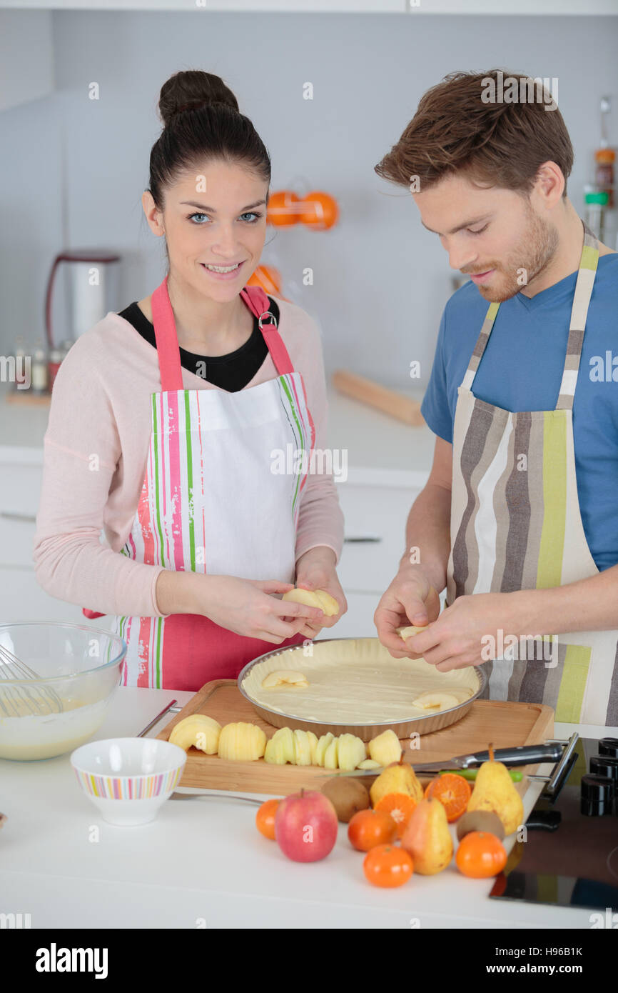 young woman and man baking a cake Stock Photo - Alamy