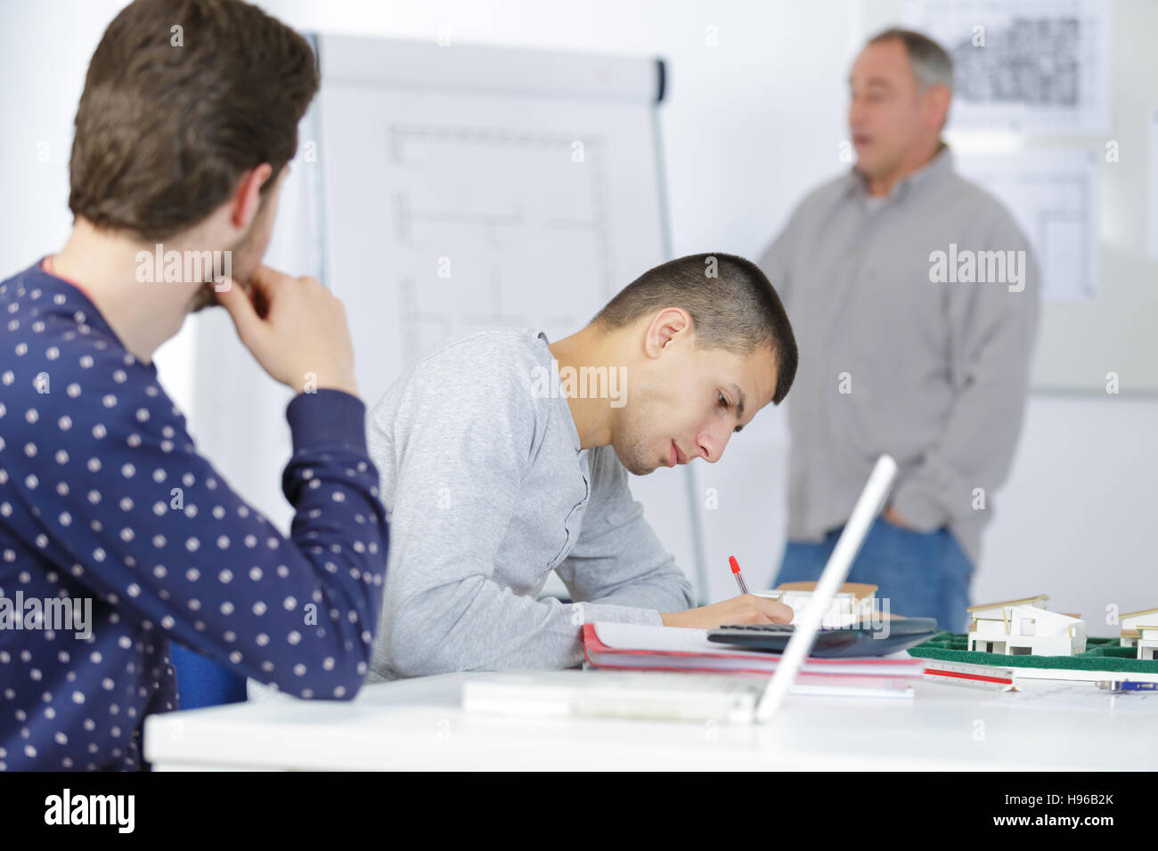 teacher explaining something to students Stock Photo - Alamy