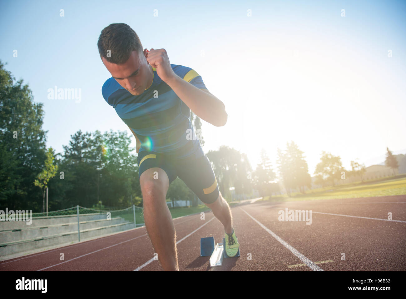 Sprinter leaving starting blocks on the running track. Explosive start ...