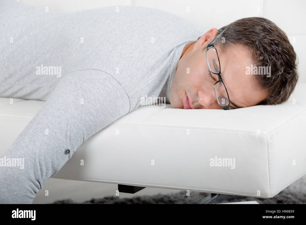 man taking a little nap on the sofa Stock Photo - Alamy