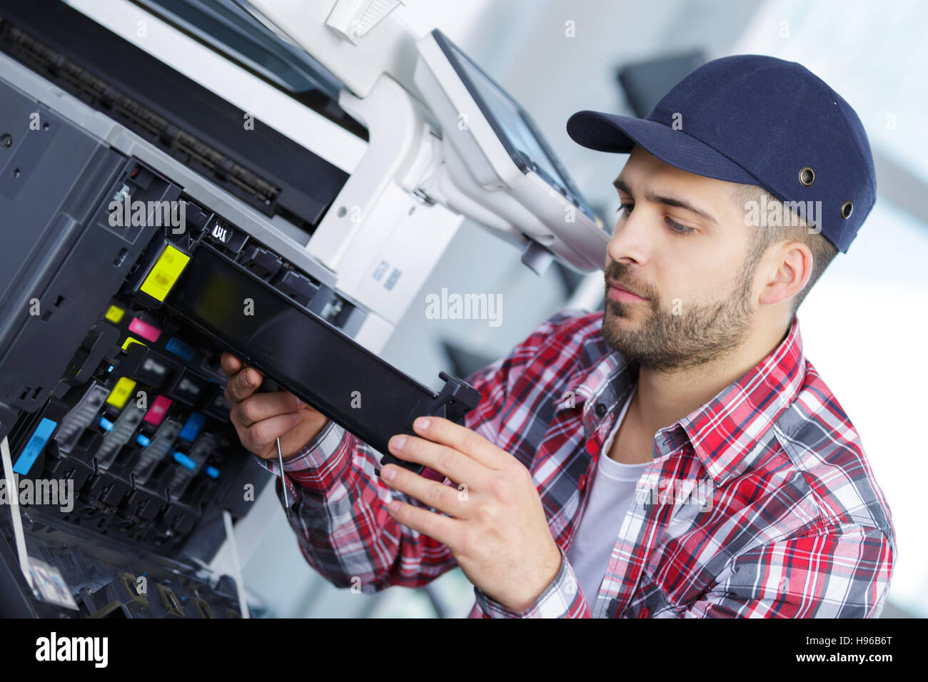 man repairing a printer at work Stock Photo - Alamy