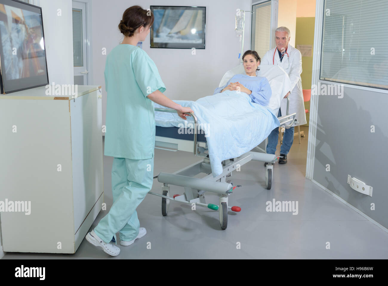 doctor and nurse translating a patient Stock Photo - Alamy