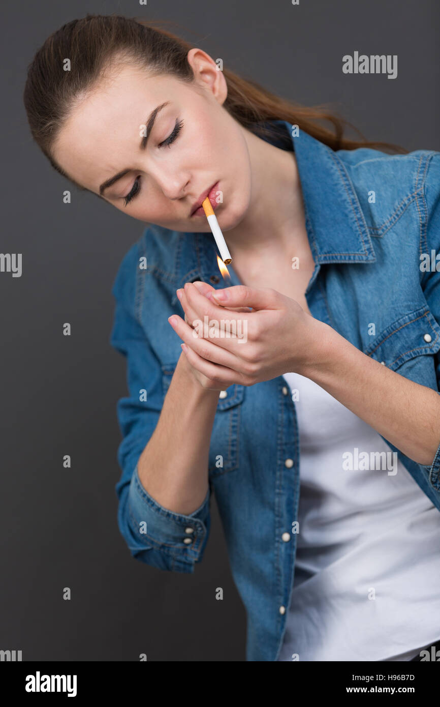 woman lighting a cigarrette Stock Photo - Alamy