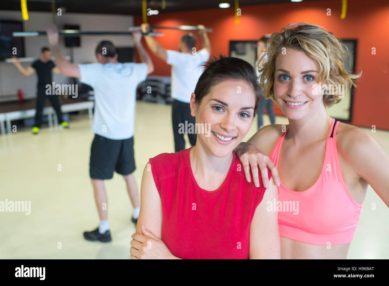happy women posing in a gym and smiling Stock Photo - Alamy
