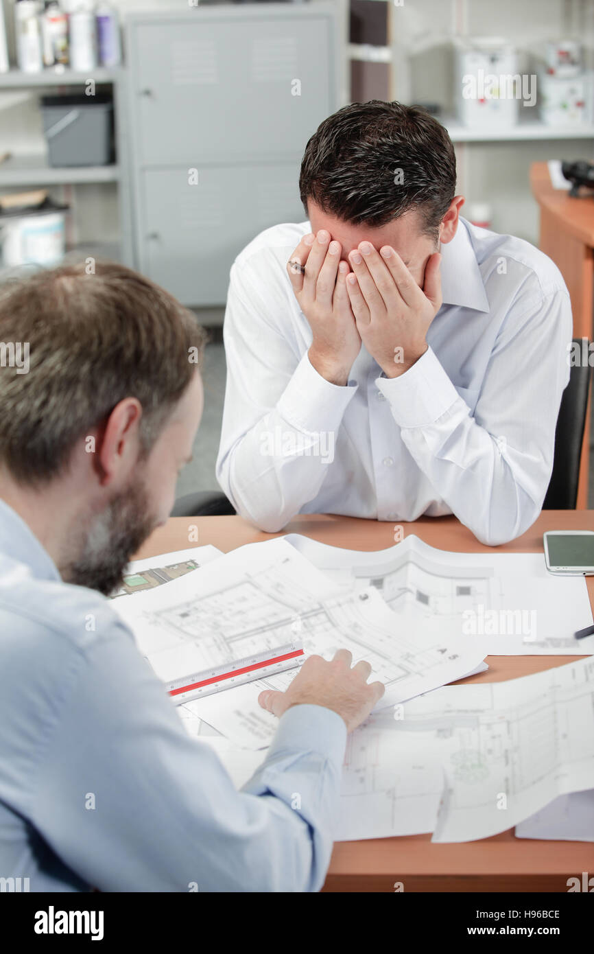 Stressed architect can't catch a break Stock Photo - Alamy