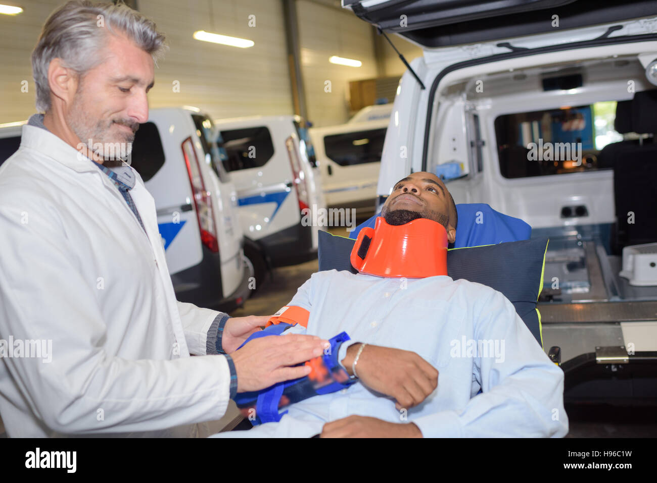 Paramedic tending to injured patient Stock Photo - Alamy