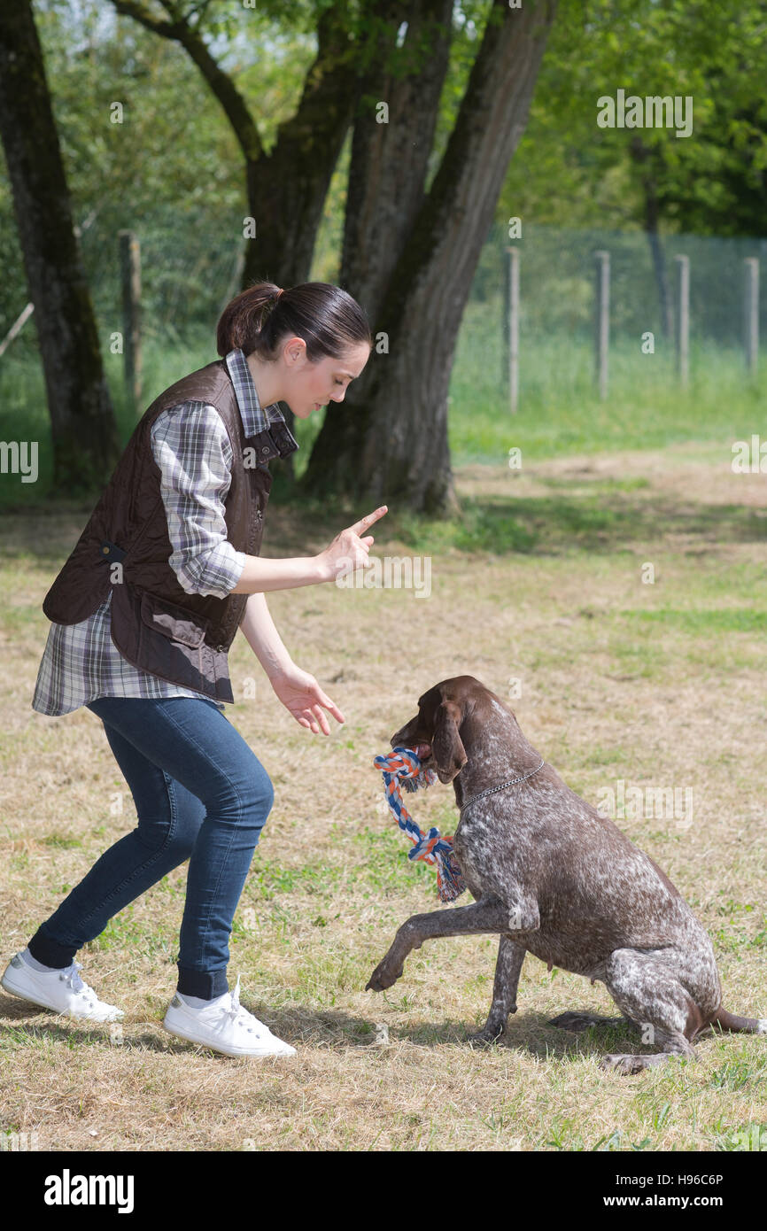 dedicated girl training dog in kennel Stock Photo - Alamy