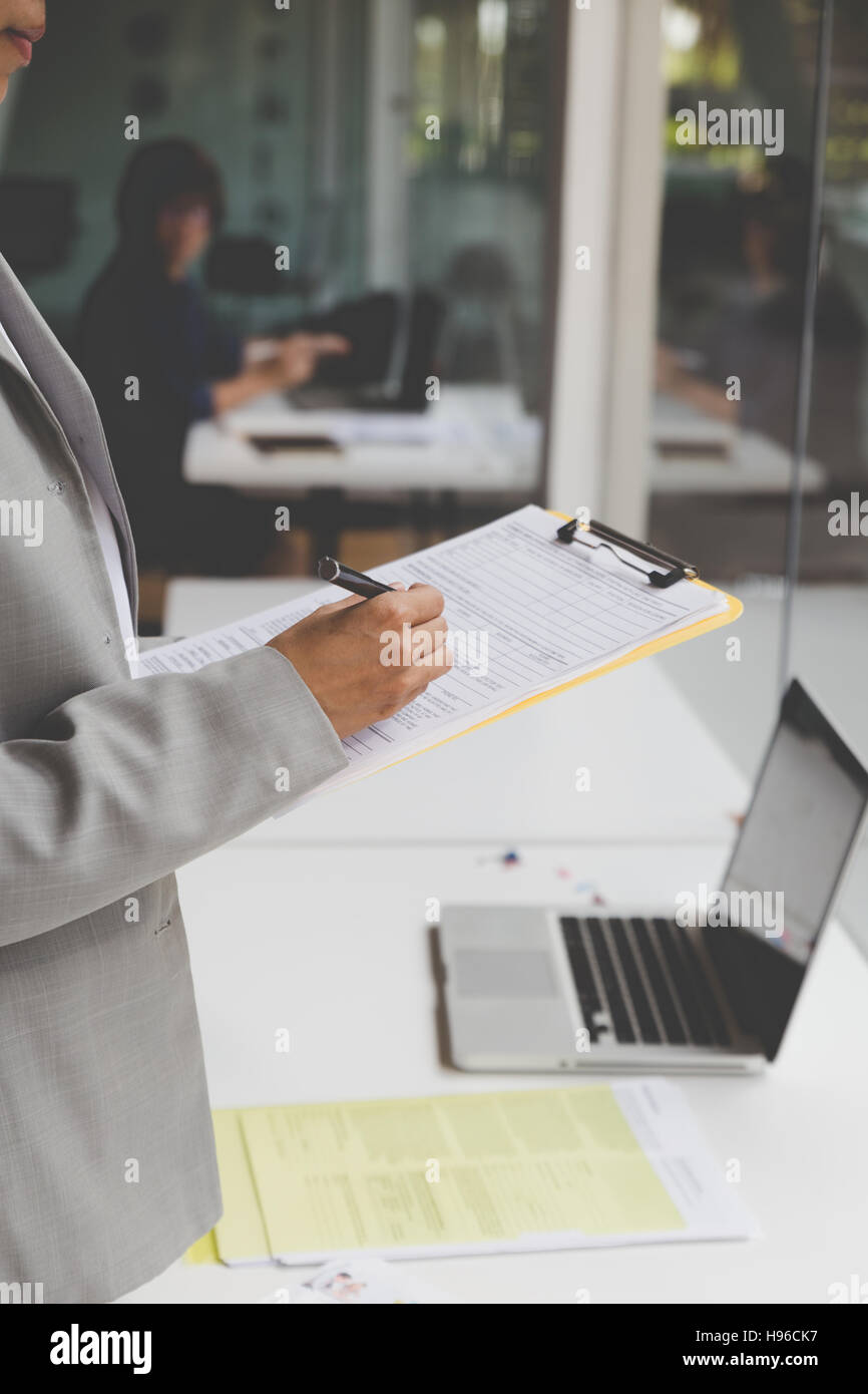 people working with document and laptop computer for use as office ...