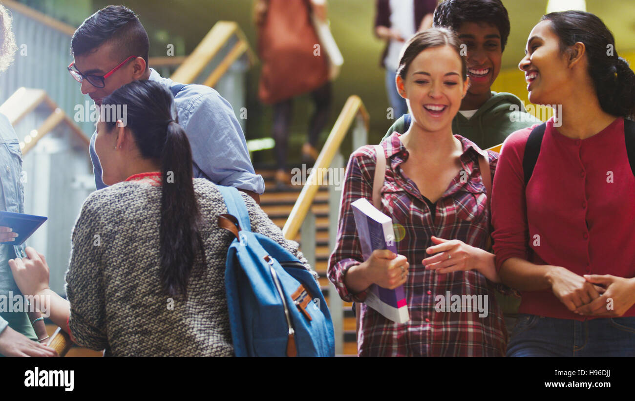 Smiling college students in stairway Stock Photo - Alamy