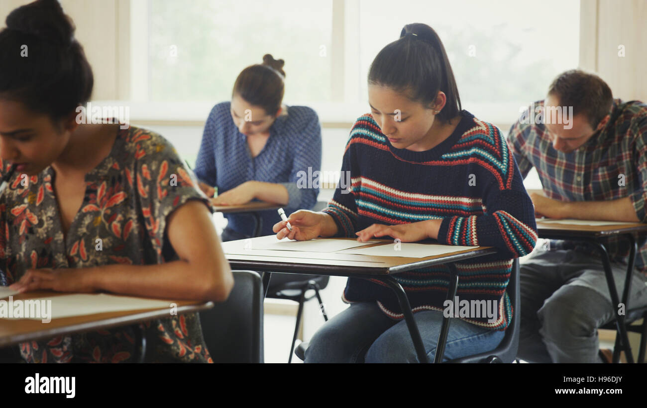 College students taking test at desk in classroom Stock Photo - Alamy