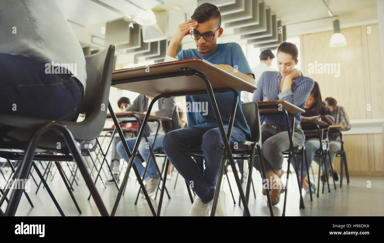 College students taking test at desk in classroom Stock Photo - Alamy