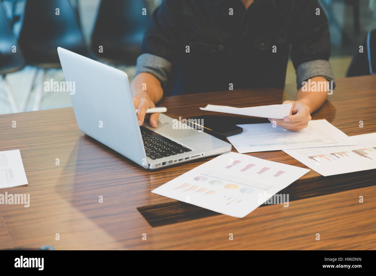 people working with document and laptop computer in office workplace ...