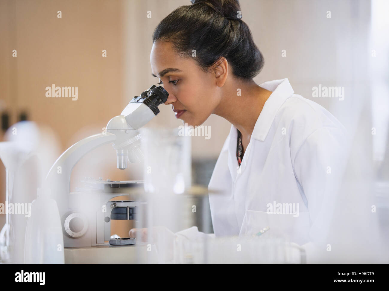 Female scientist using microscope in laboratory Stock Photo - Alamy