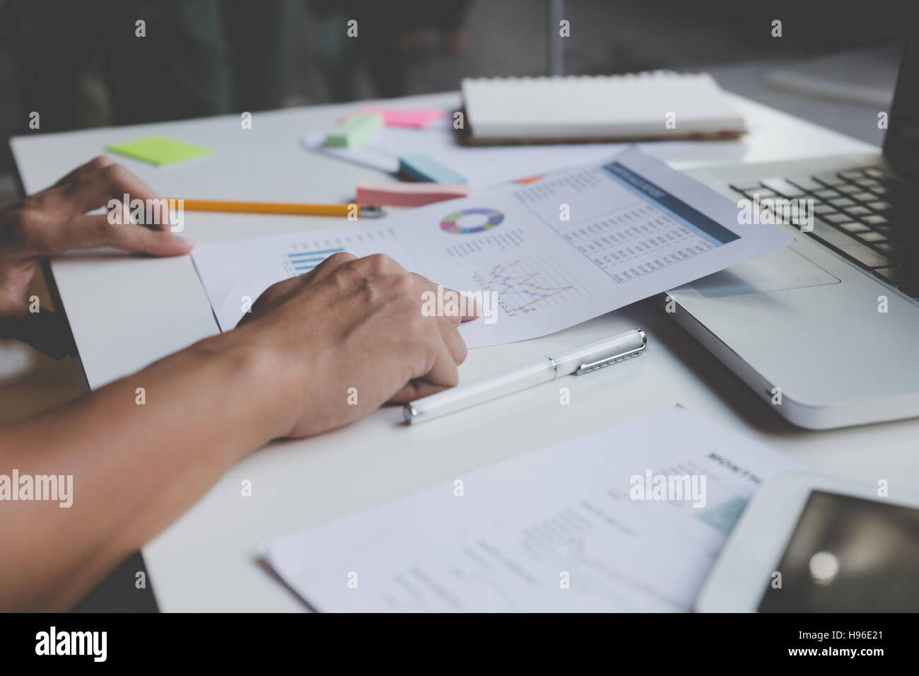 people working with document and laptop computer for use as office ...