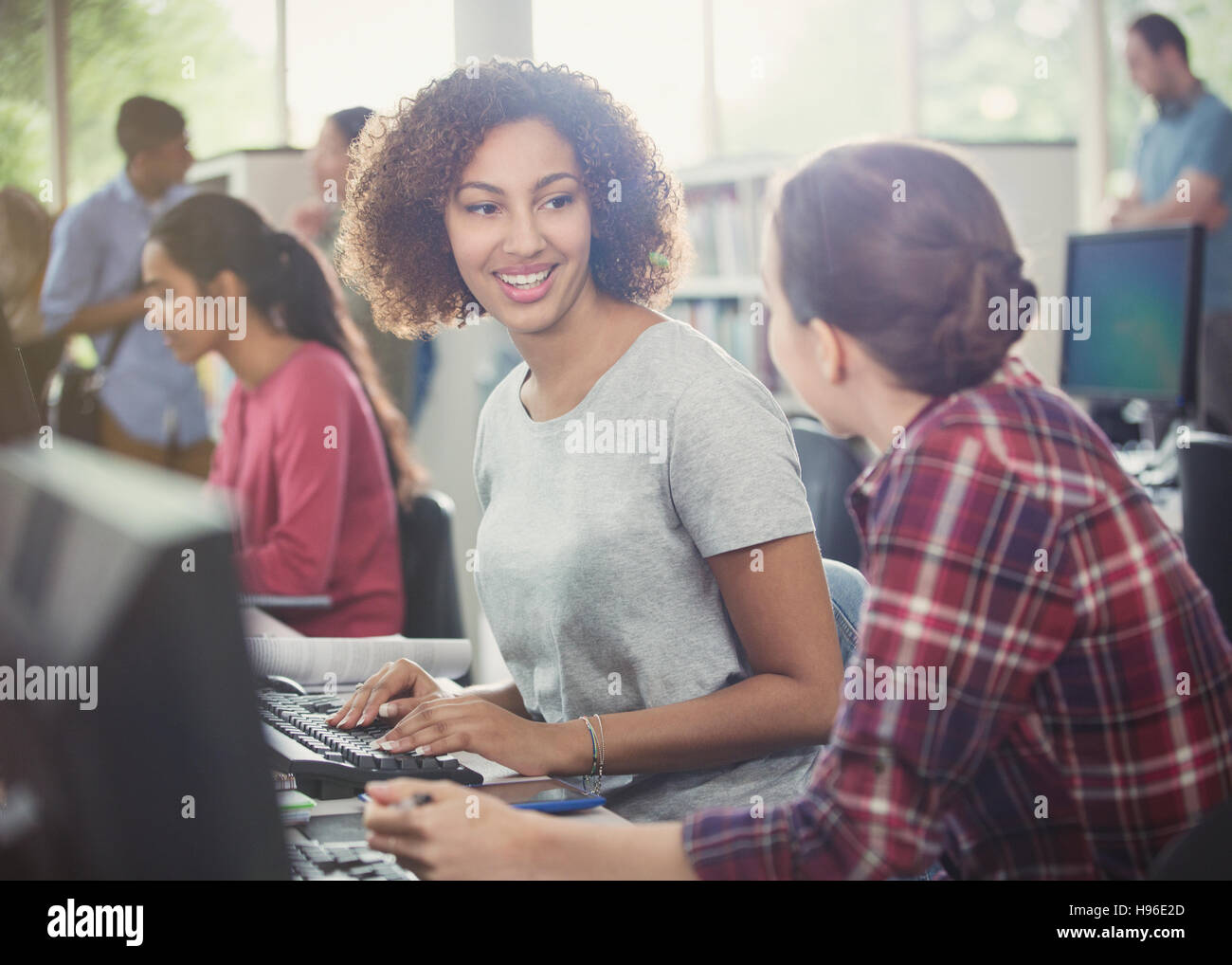 Female college students using computers in computer lab library Stock ...
