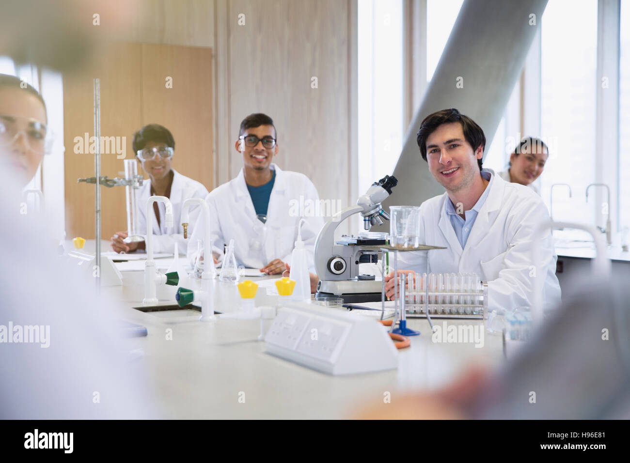 Portrait smiling college students in science laboratory classroom Stock ...