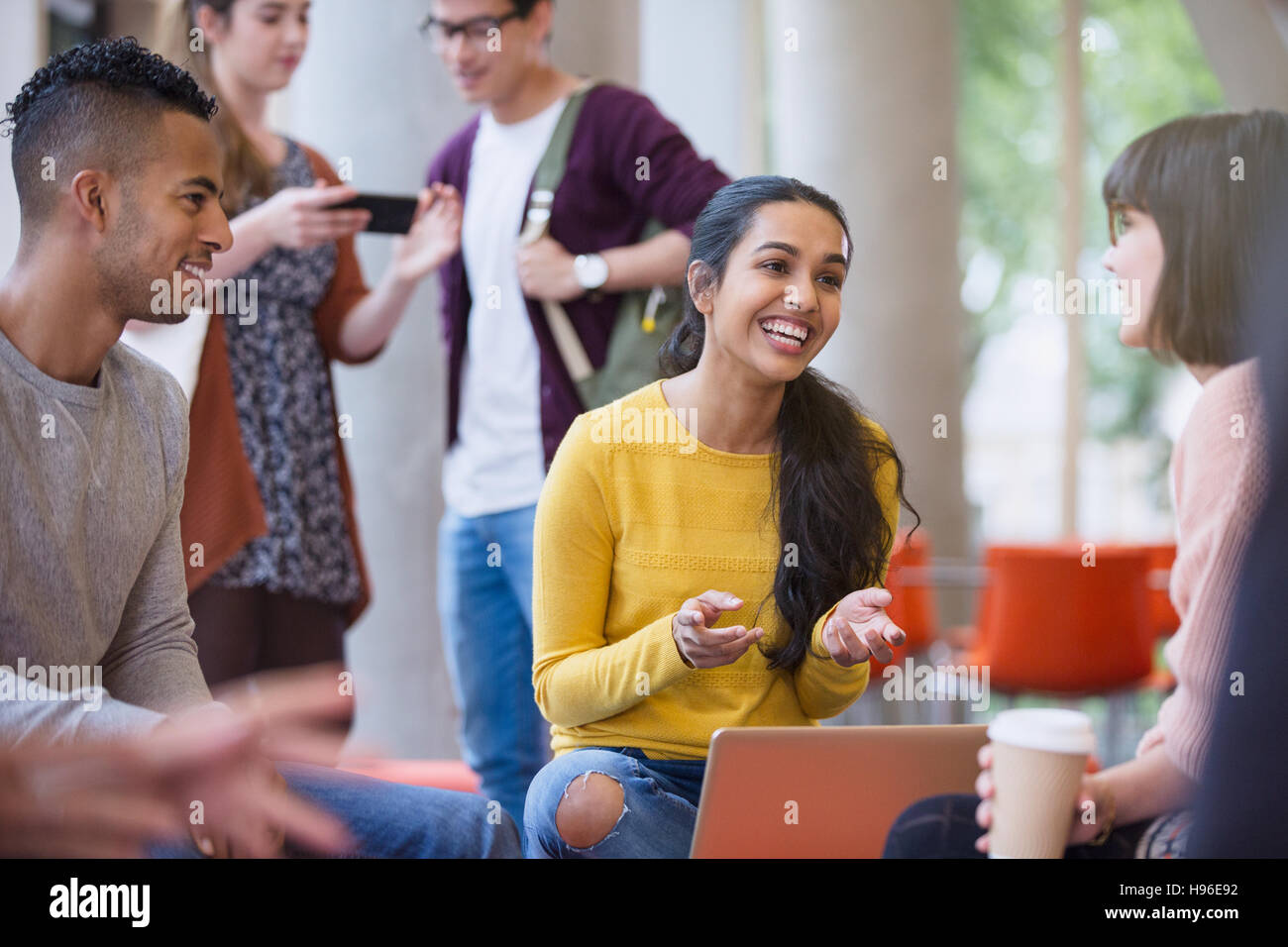 Smiling college students talking and drinking coffee in commons Stock ...