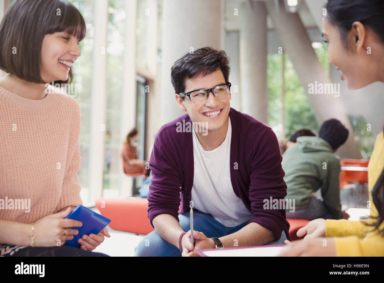 Smiling college students talking in commons Stock Photo - Alamy