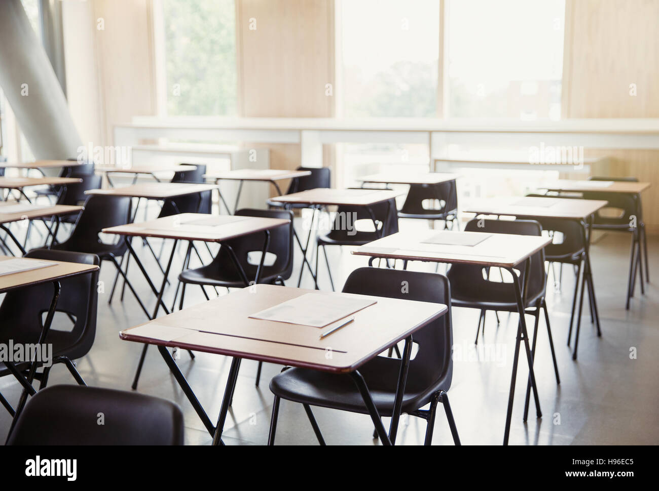 Tests on desks in empty classroom Stock Photo - Alamy
