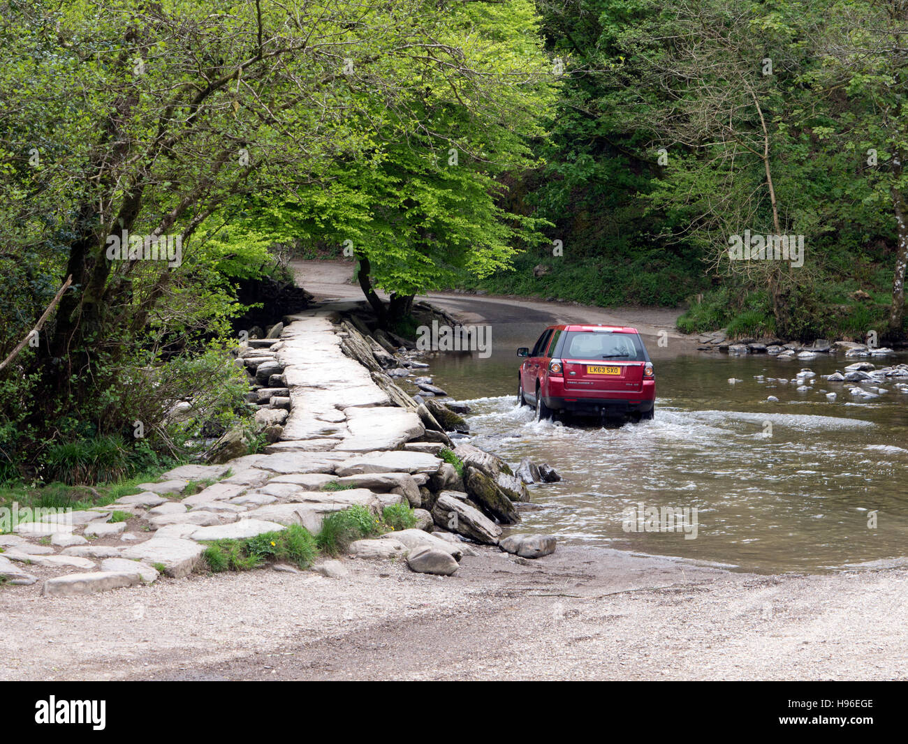Car driving through River Barle, beside Tarr Steps, Exmoor National ...