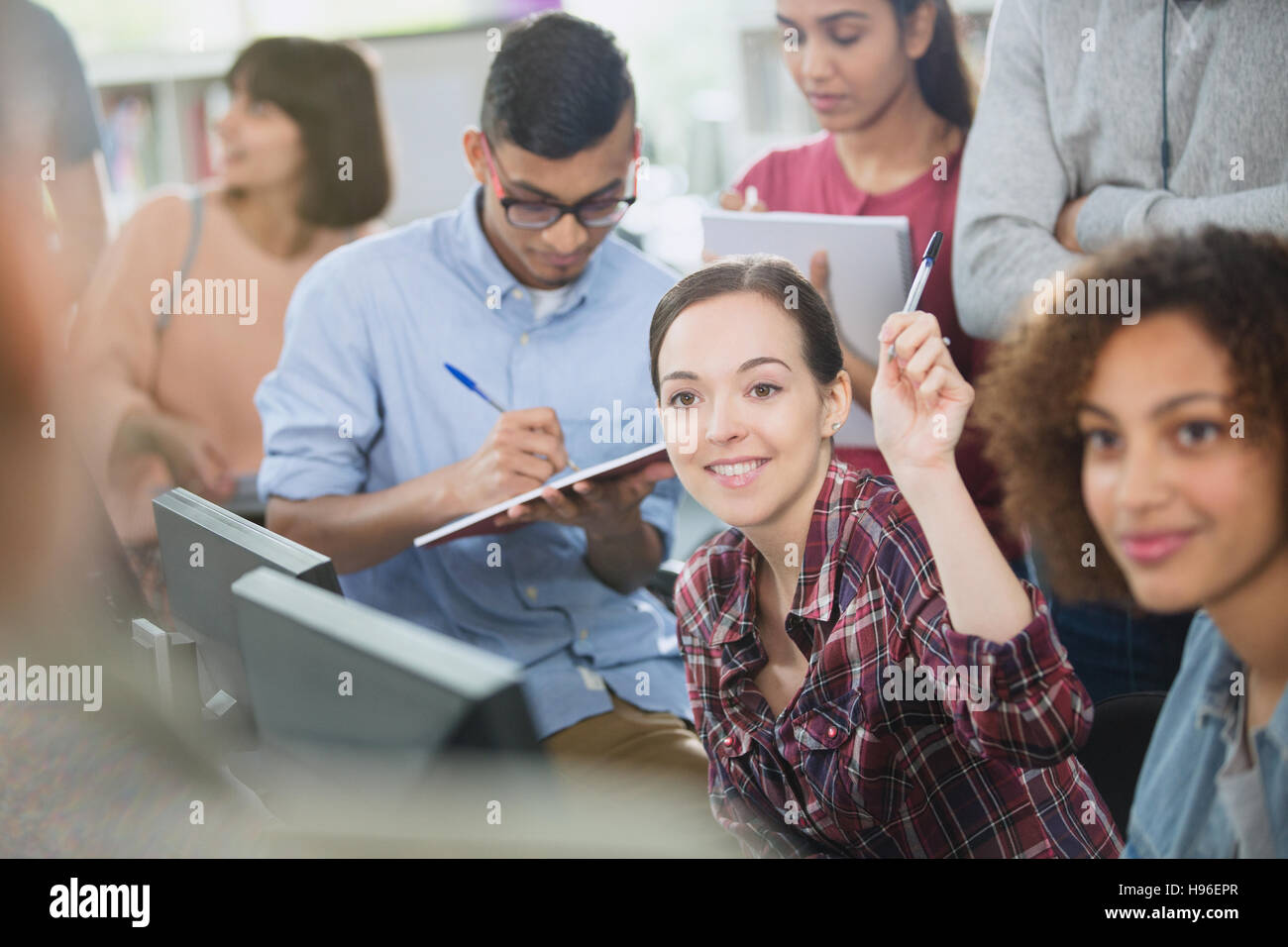 College student raising hand in computer lab classroom Stock Photo - Alamy