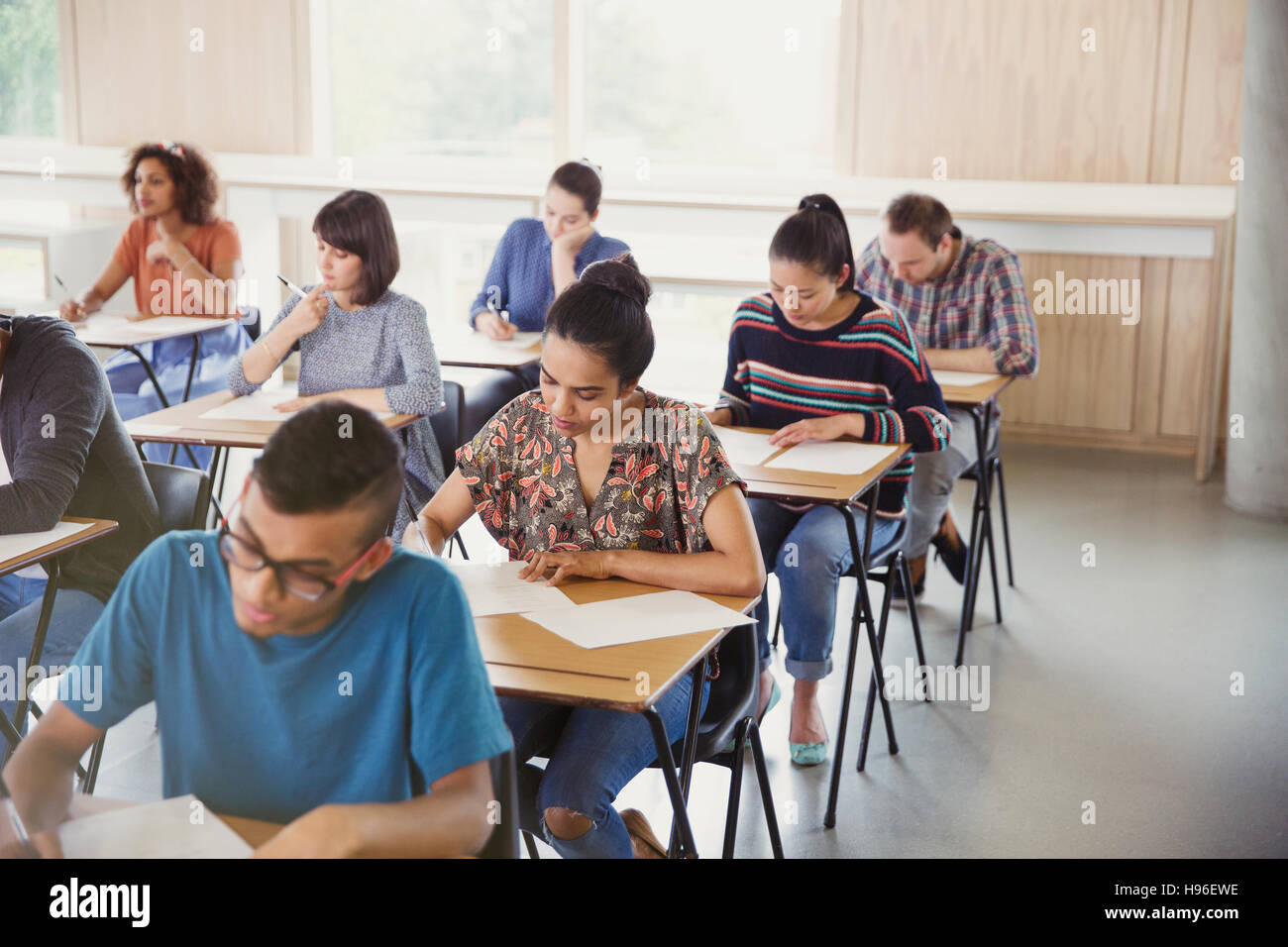 College students taking test at desks in classroom Stock Photo - Alamy