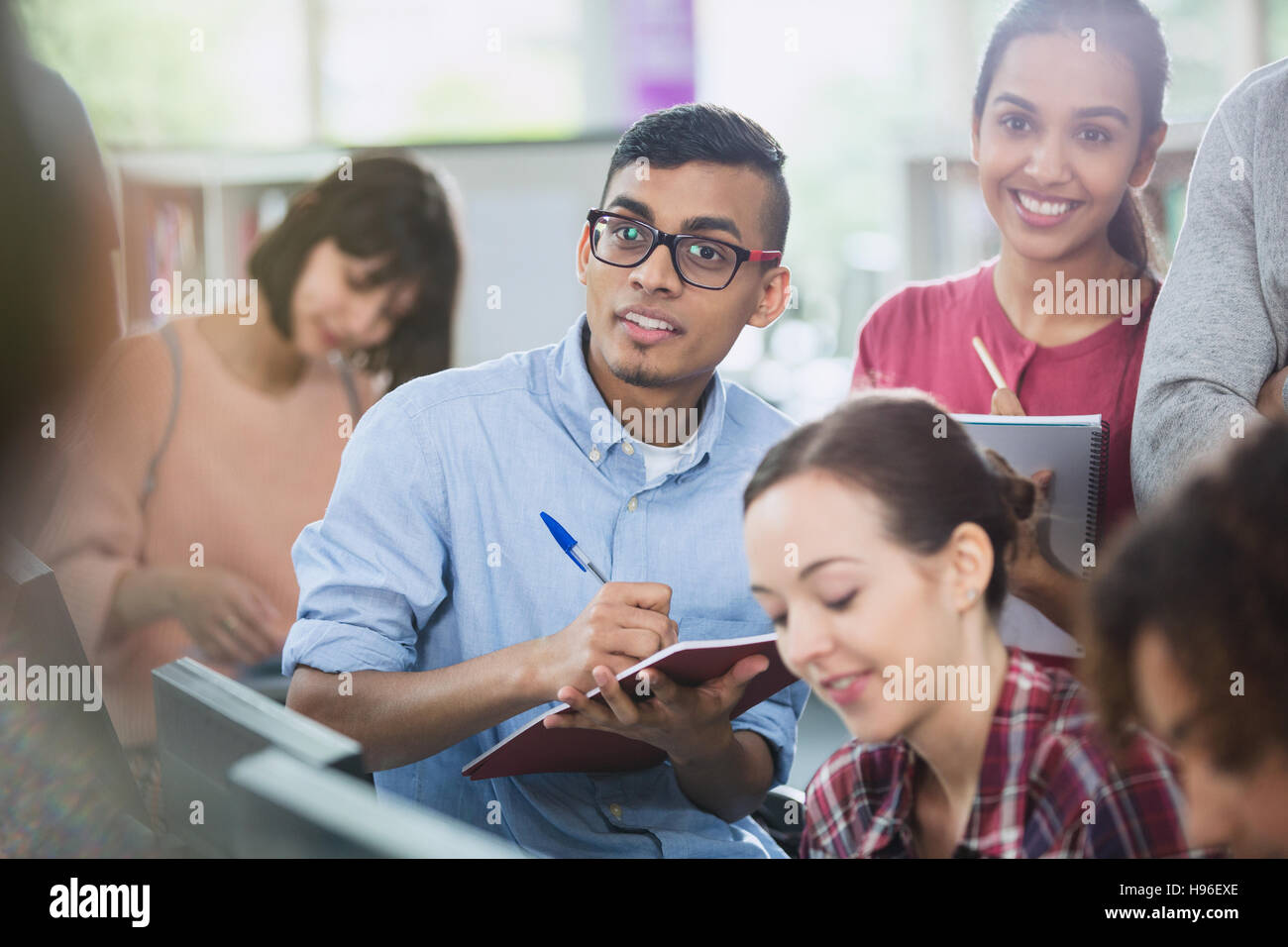 College students taking notes in classroom Stock Photo - Alamy