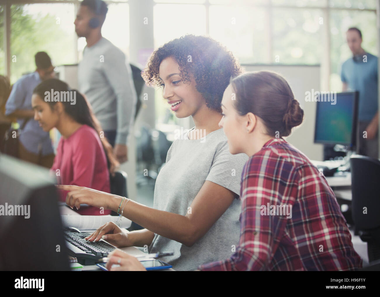 Female college students using computer at computer lab library Stock ...