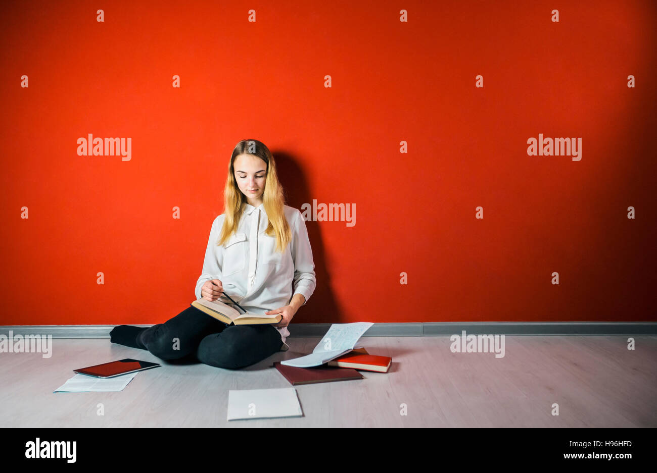 Persistent Young Student Girl Studying on Floor Stock Photo - Alamy