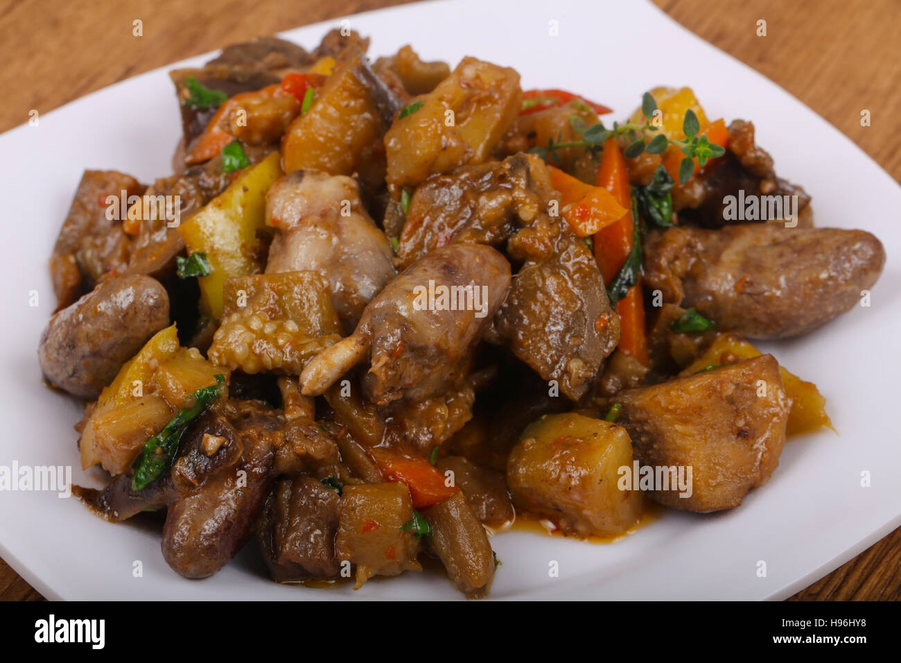 Chicken hearts with vegetables - eggplant, tomato and pepper Stock ...