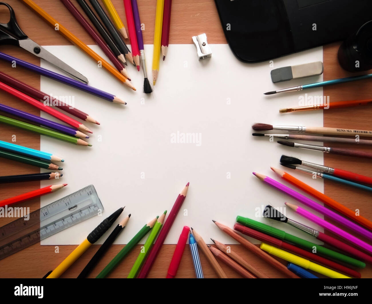 Blank paper, graphics tablet, brushes and colorful pencils on the ...