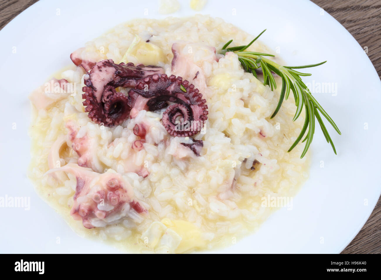 Risotto with octopus served green rosemary Stock Photo - Alamy