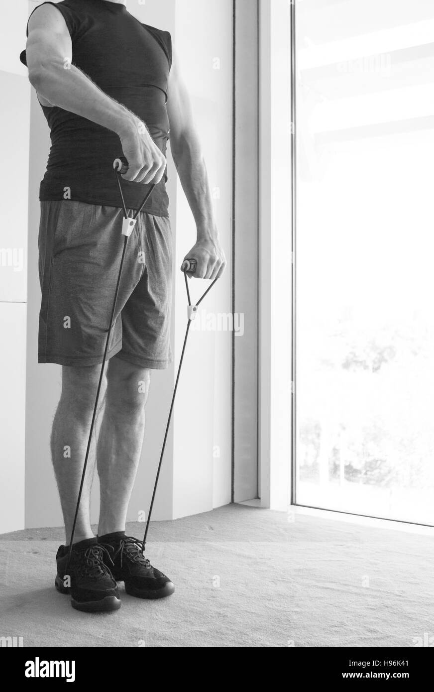 Performing exercises with resistance rope fitness Stock Photo - Alamy