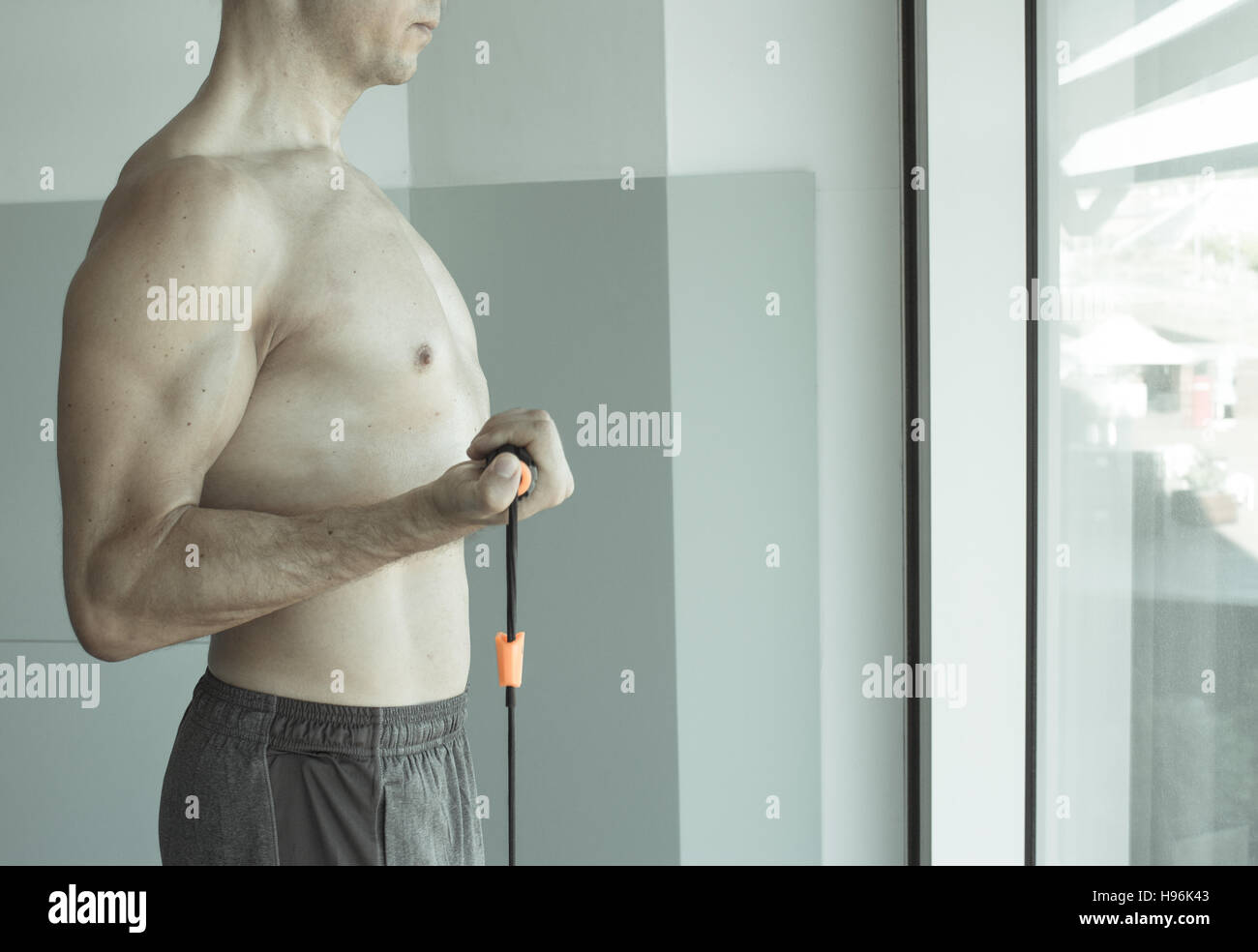 Performing exercises with resistance rope fitness Stock Photo - Alamy