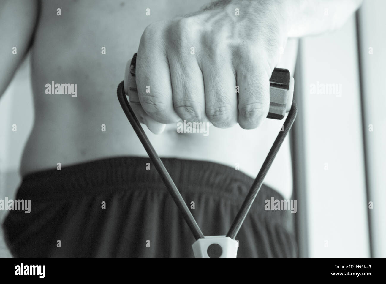 Performing exercises with resistance rope fitness Stock Photo - Alamy