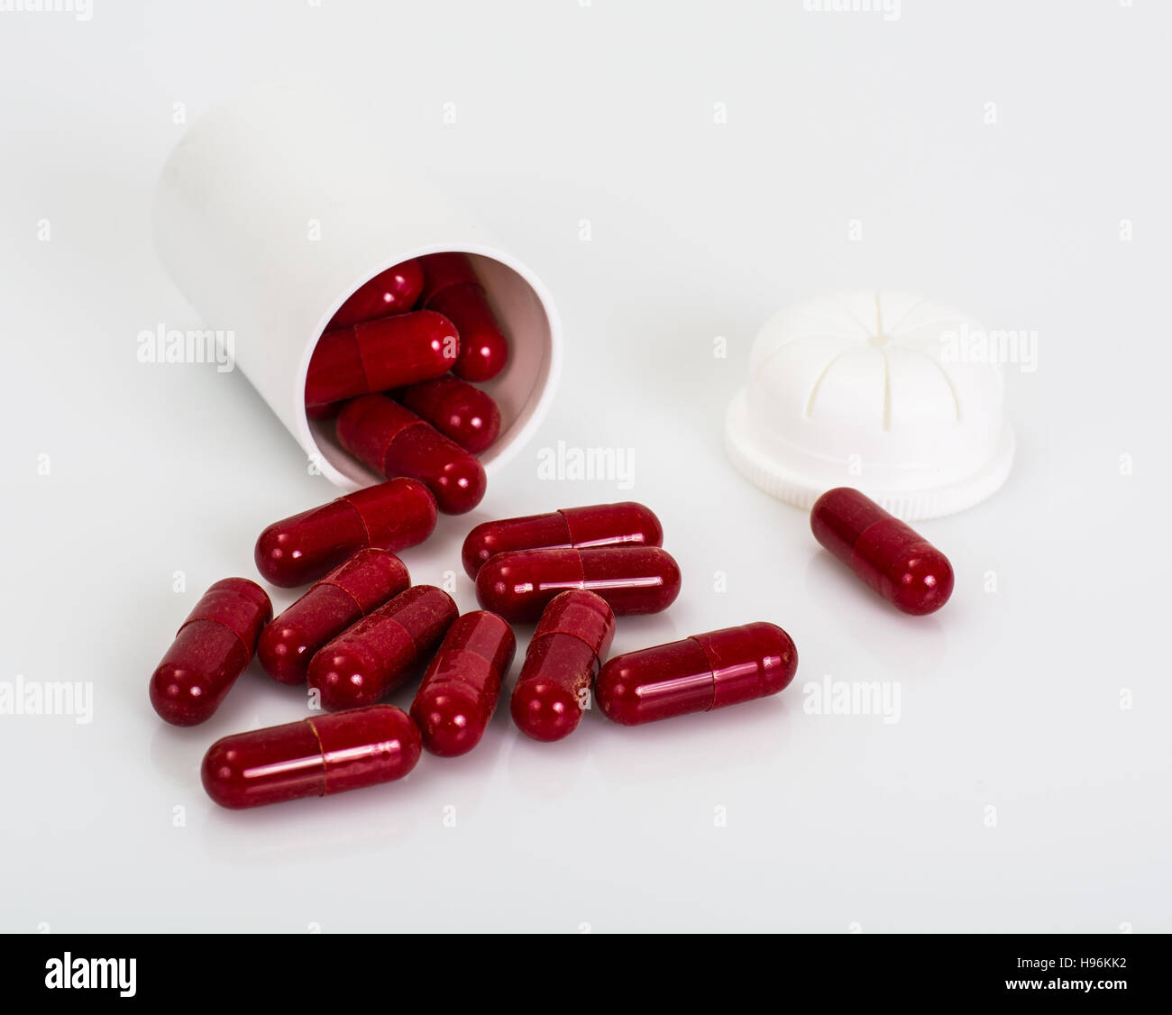 Capsules red on a white background. Studio Photo Stock Photo - Alamy