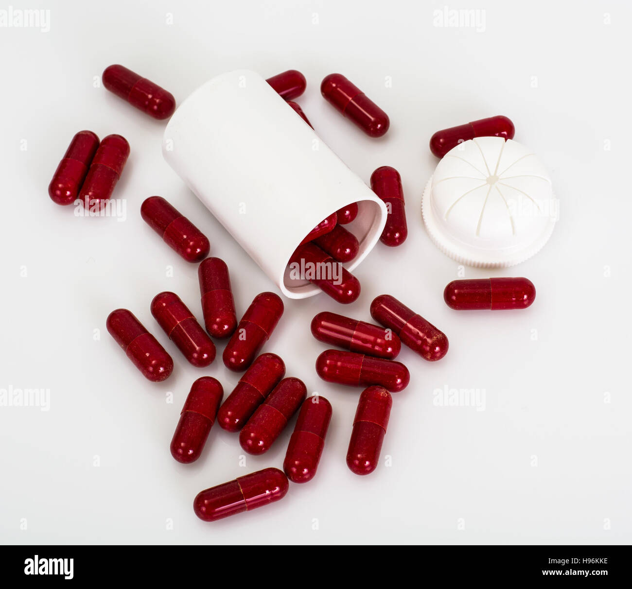 Capsules red on a white background. Studio Photo Stock Photo - Alamy