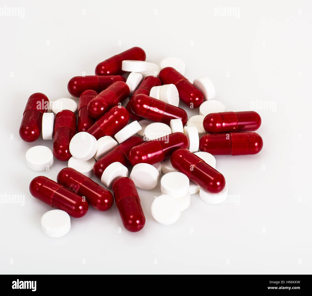 Capsules red on a white background. Studio Photo Stock Photo - Alamy