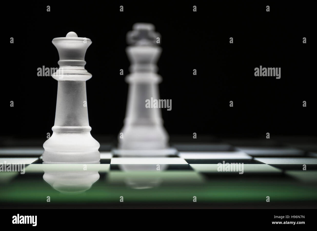 Chess queen and king on chess board Stock Photo - Alamy