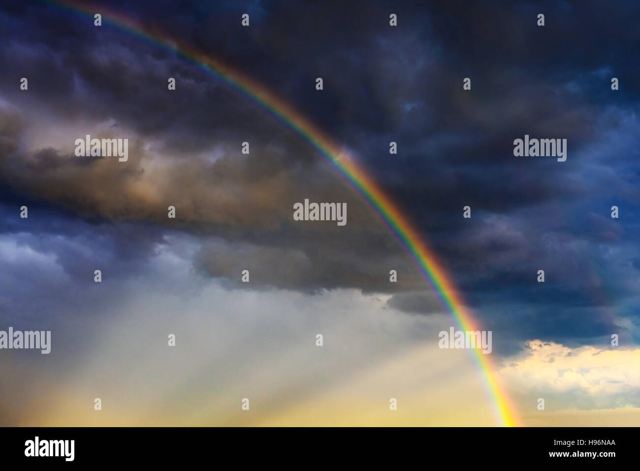 Multi colored dramatic sky with rainbow Stock Photo - Alamy