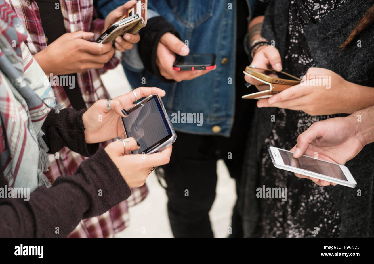 Young people outdoors using smartphones Stock Photo - Alamy