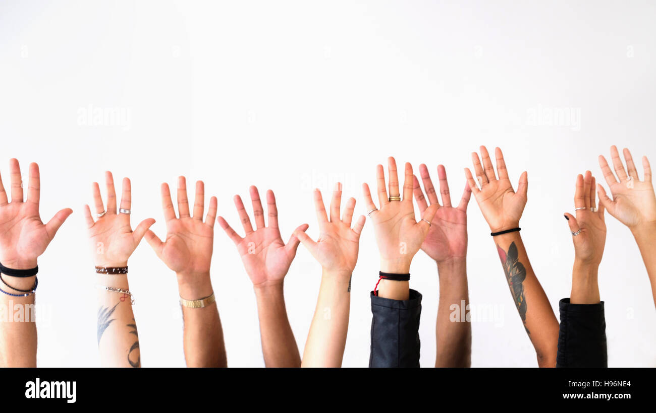 Raised hands against white background Stock Photo - Alamy