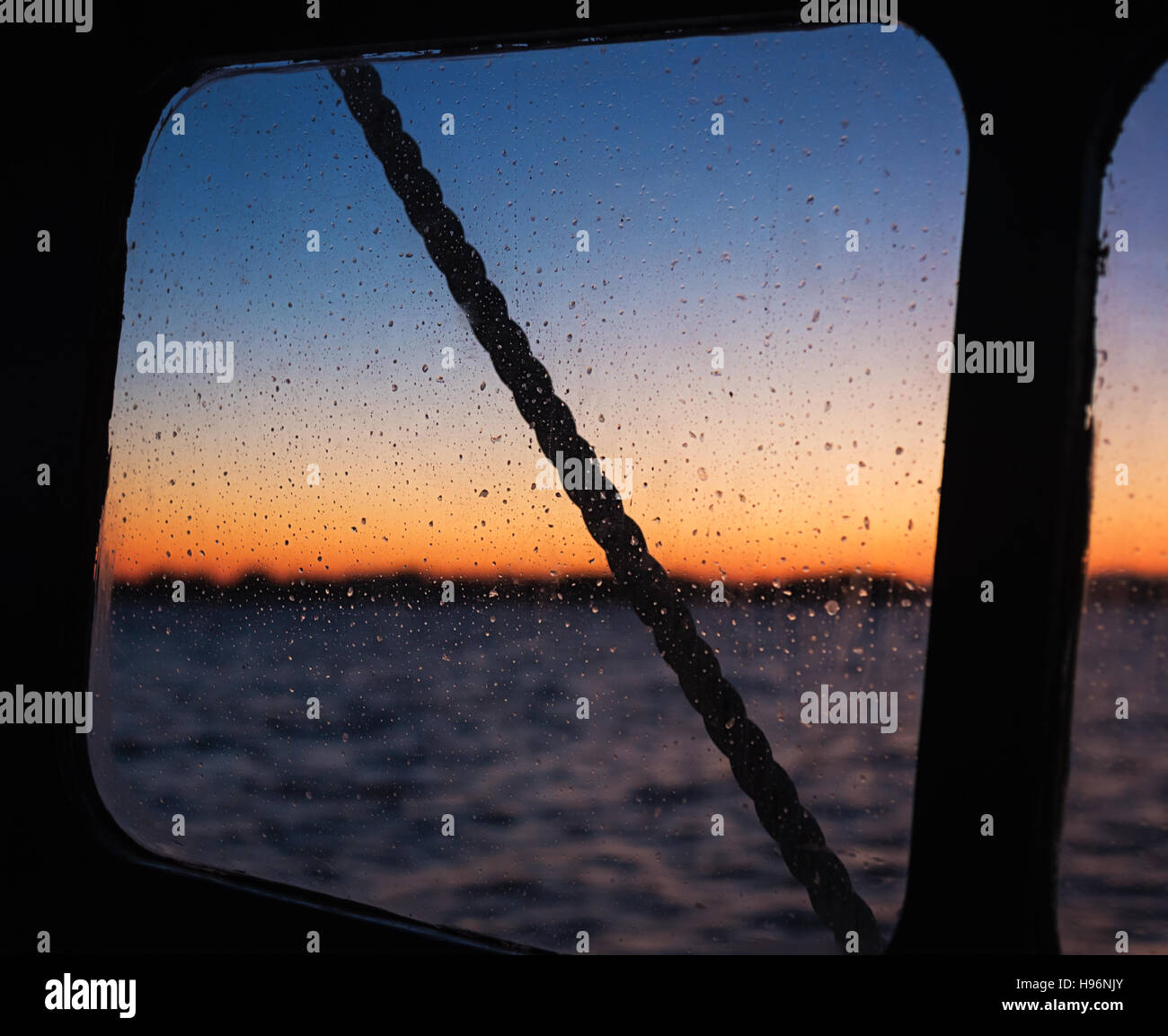 Sea at sunset seen through boat window Stock Photo - Alamy