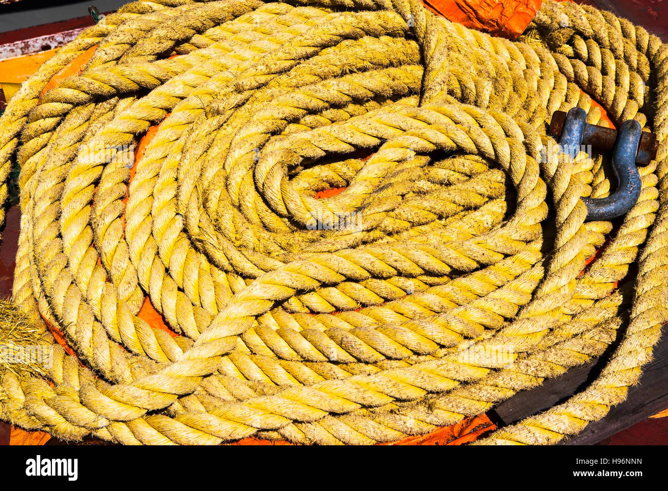Coil of yellow rope with hook Stock Photo - Alamy